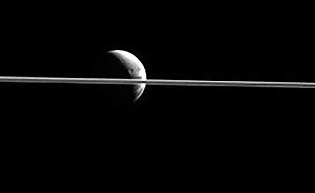 NASA Releases Stunning Photos of Saturn 'Cutting' Its Moon in Half